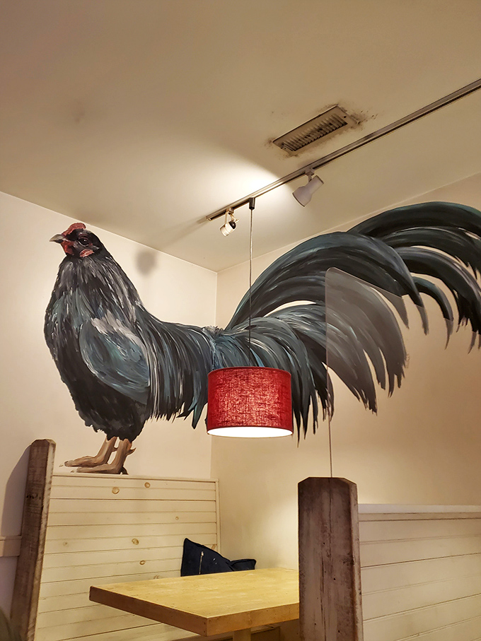 That magnificent rooster mural watches over diners like a breakfast guardian angel. He's silently judging anyone who orders their eggs well-done.
