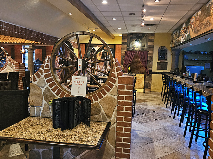 Rustic stone, brick accents, and that statement wagon wheel create an atmosphere that says, "Stay awhile." The host stand awaits to guide you to your flavor journey.