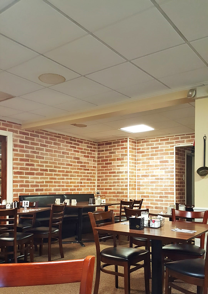 Exposed brick walls and simple wooden tables create that rare atmosphere where both truckers and bankers feel equally at home.