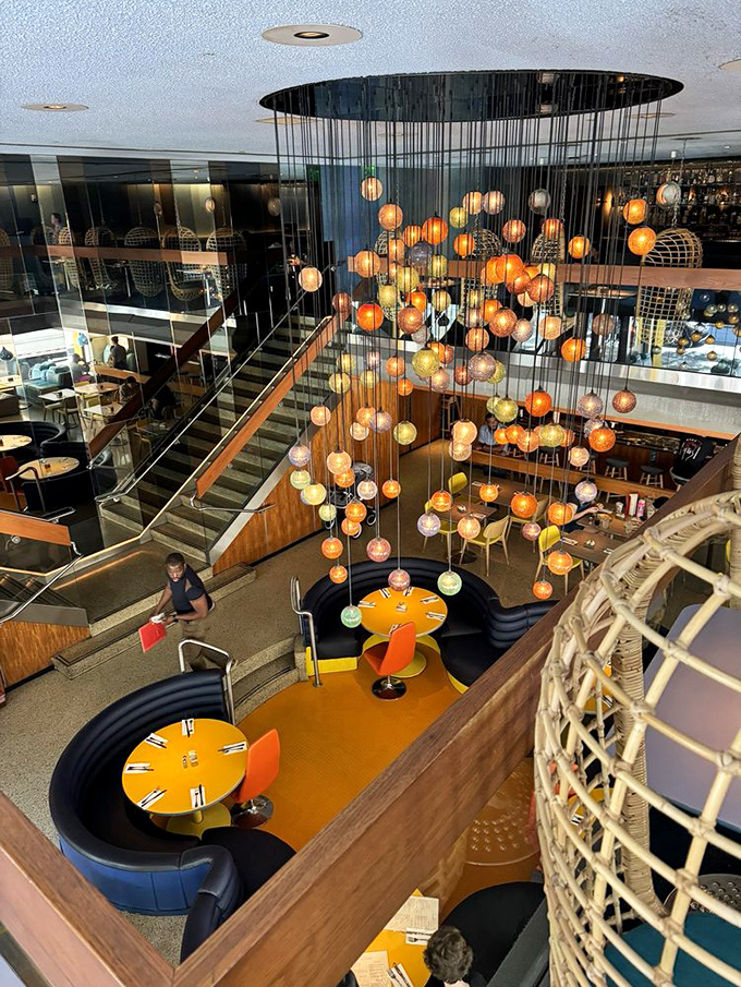 Looking down from above reveals the restaurant's genius design &ndash; a multi-level playground for grown-ups with those signature curved booths and vibrant colors.