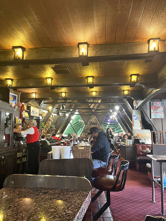 Lantern-style lighting casts a warm glow over the A-frame interior, creating that rare atmosphere where both early birds and late risers feel equally welcome.