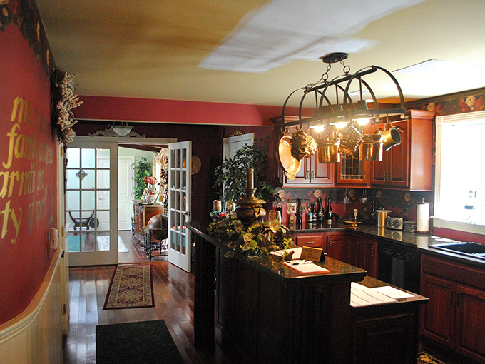 This kitchen may have modern appliances, but its warm wood and hanging copper pots channel the cozy heart of a country estate.