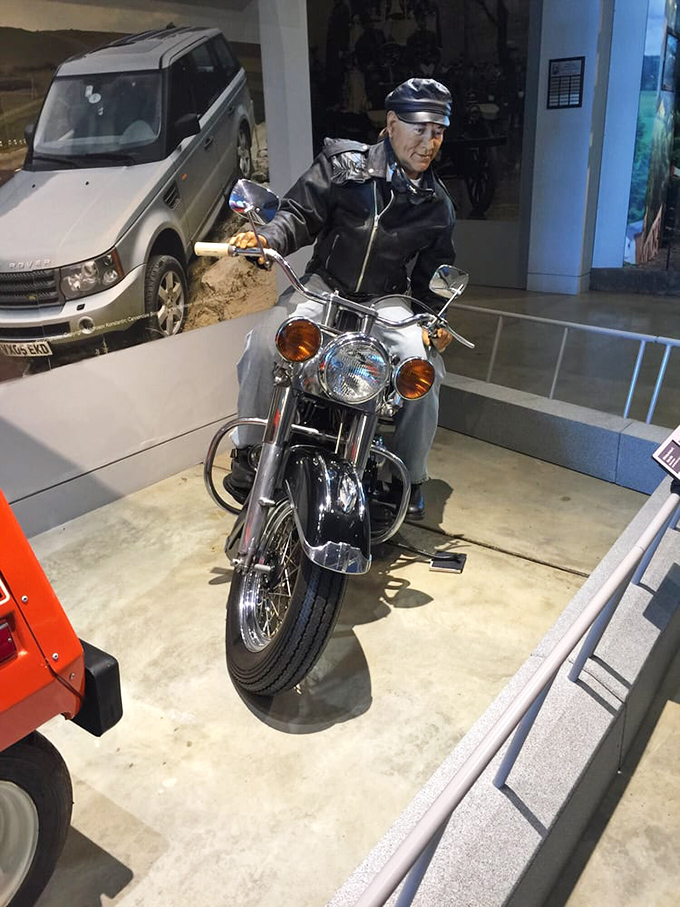 This motorcycle display features a lifelike figure ready for the open road, capturing that universal feeling of freedom that comes with two wheels and an open throttle.