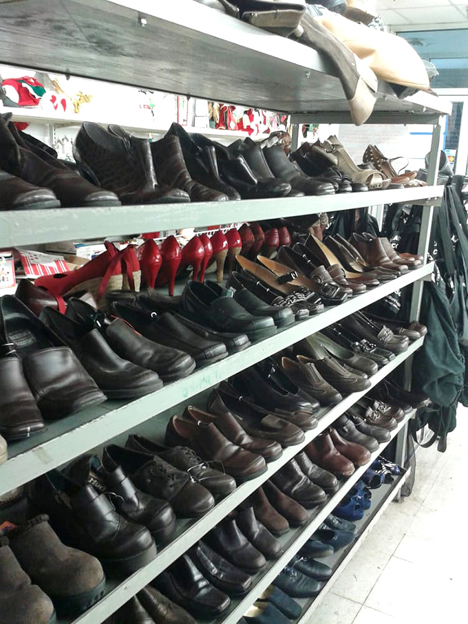 Rows of men's shoes stand like soldiers awaiting inspection, from office-ready oxfords to weekend work boots with plenty of life left.