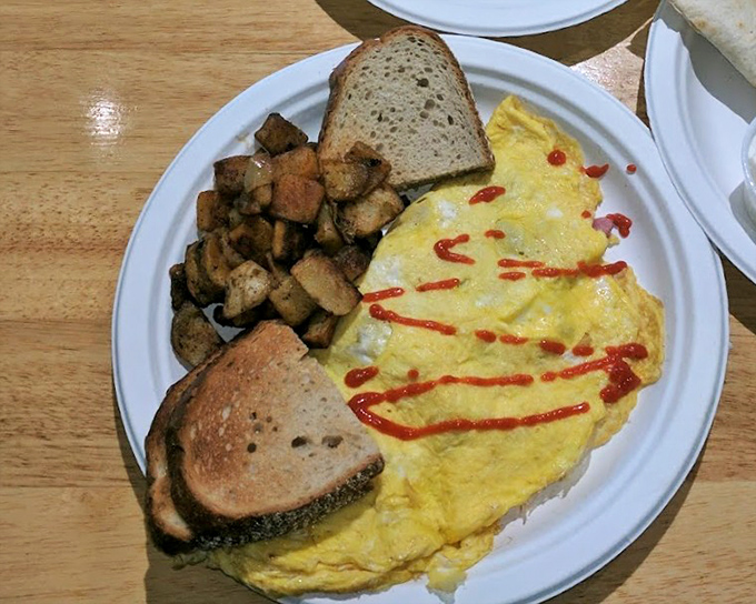 This isn't just an omelet&mdash;it's breakfast architecture, with home fries standing guard and toast ready to soak up every last morsel.