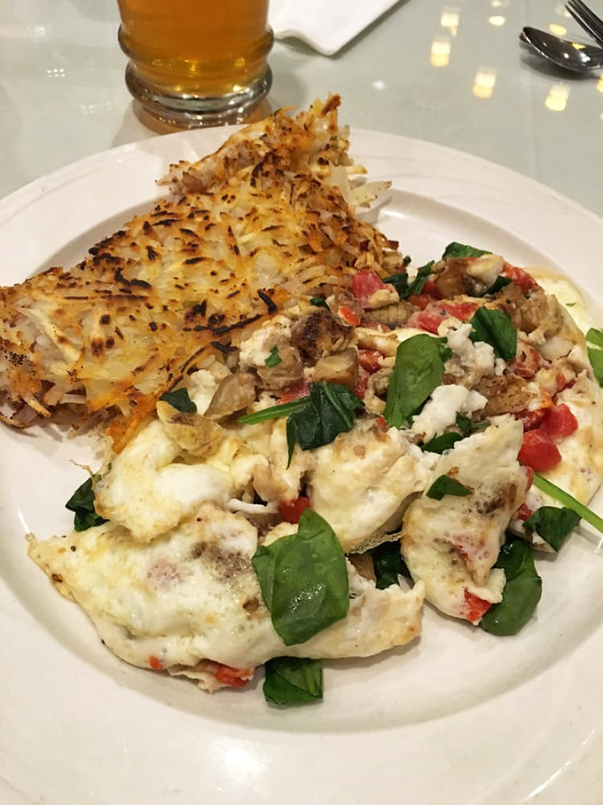 An omelet that's had a meaningful relationship with vegetables, served alongside hash browns that achieved the perfect crisp-to-tender ratio.
