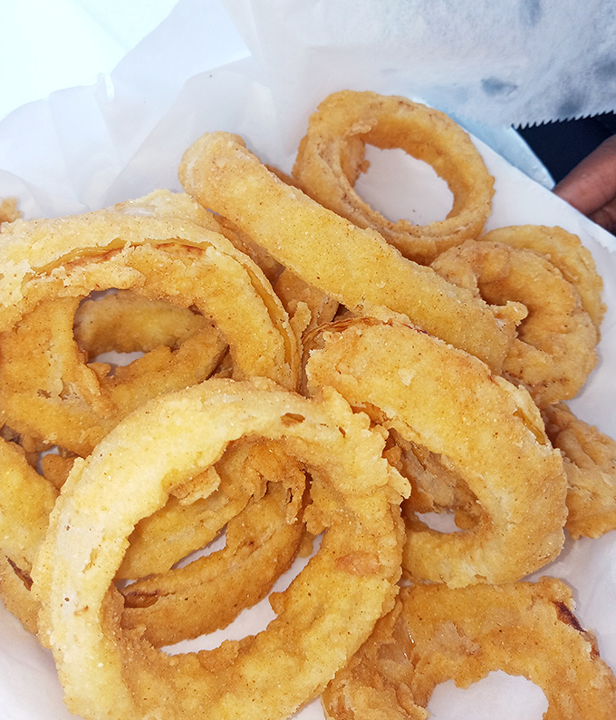 Onion rings with the perfect crunch-to-softness ratio. Each golden hoop is like winning a tiny, delicious Olympic medal.