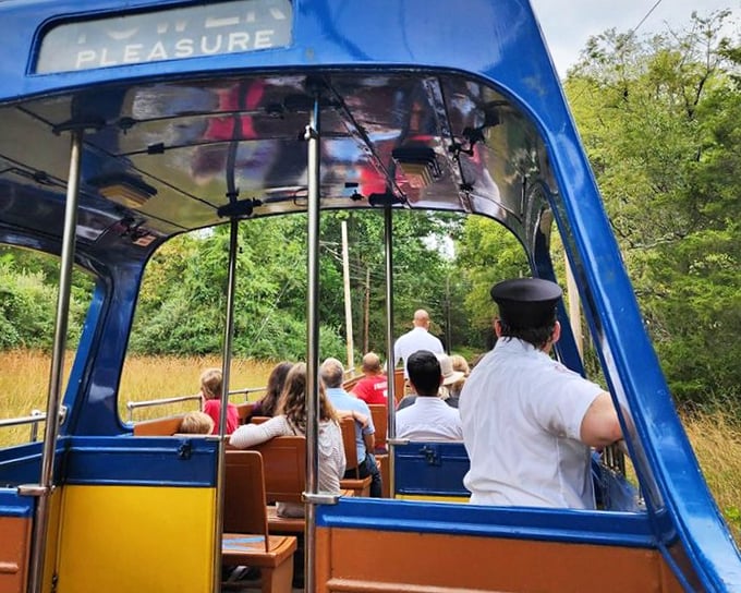 All aboard for adventure! Passengers enjoy the open-air experience while a conductor in crisp uniform guides them through a journey into yesterday.