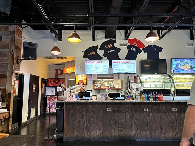 The command center where heat levels are negotiated and brave orders are placed. Those t-shirts on display? Badges of honor for survivors.