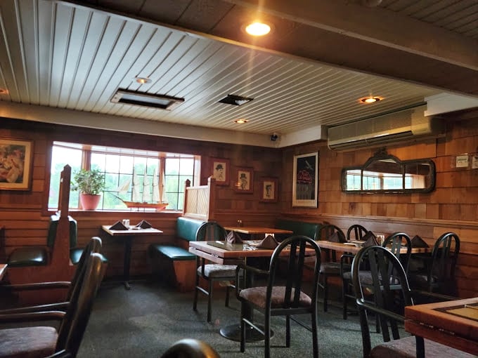 Cozy booths and wood-paneled walls make this dining room feel like the captain's quarters of a luxury yacht&mdash;minus the seasickness.