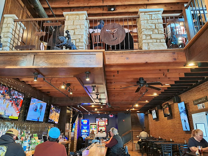 The multi-level interior creates different dining zones like chapters in a delicious story. Wood beams above add warmth that no designer could fake.