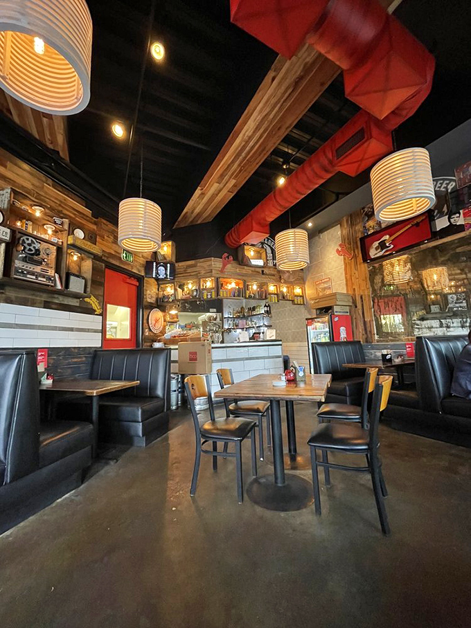 Booth seating that invites lingering conversations, beneath cylindrical lampshades casting the kind of light that makes everyone look their best.