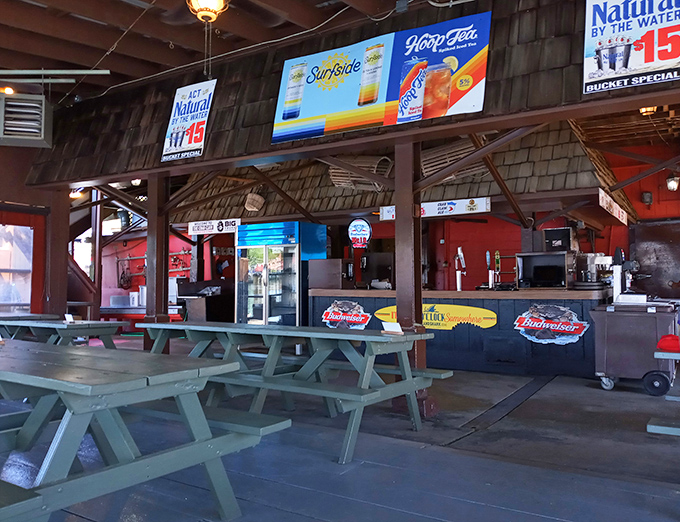 The outdoor counter serves up summer in liquid form, with colorful signs promising cold beer and seafood treasures just steps from the water.