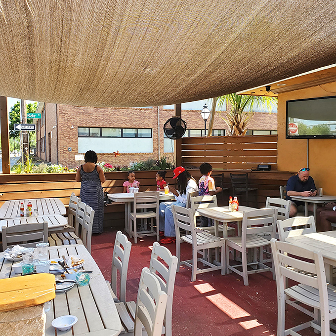 Families gather under the shade cloth on the patio, creating memories one bite at a time in this neighborhood institution.