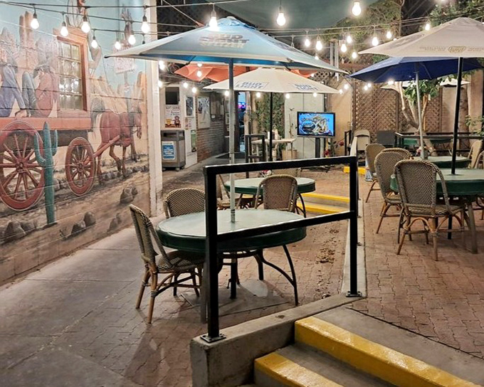 The outdoor patio offers desert dining under string lights, where southwestern murals and cool evening breezes enhance every bite.