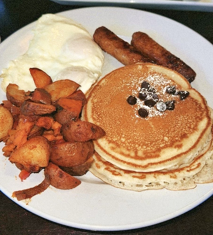 Pancakes stacked high, dotted with blueberries and accompanied by potatoes and sausage&mdash;the breakfast trifecta that makes mornings worth facing.