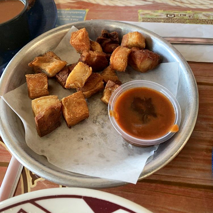 Pork belly bites &ndash; the candy of the meat world. These golden-brown cubes of happiness come with sauce, but honestly, they're perfect just as they are.