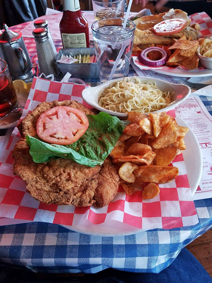 A sandwich that requires both hands, several napkins, and absolutely no concern for maintaining dignity while experiencing pure pork paradise.