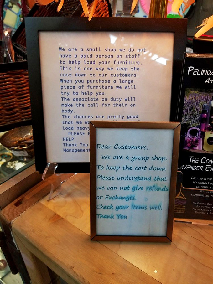Honest store policies framed as politely as possible. The "we don't have staff to help load furniture" sign is peak small business reality.