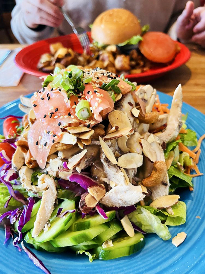 A salad that's trying to make up for all your dietary sins. The salmon and nuts are saying, "We've got your back" while secretly tasting too good to be healthy.