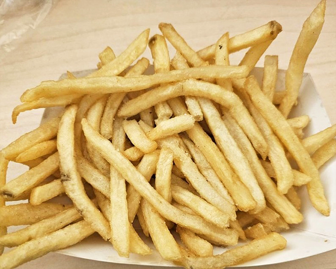 Fries that understand their purpose in life is to be golden, crispy, and abundant. No skimpy portions here&mdash;just potato perfection in paper.