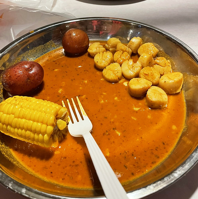 Scallops bathing in spiced sauce with corn and potatoes&mdash;a seafood hot tub party where everyone's invited to dive in.