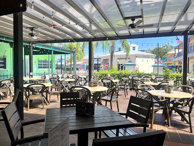 The covered patio seating area offers Florida dining without Florida sweating&mdash;palm trees included at no extra charge.