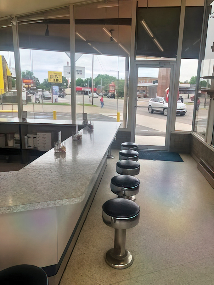 Classic diner stools facing windows &ndash; the perfect perch for people-watching while savoring sweet morning rituals.