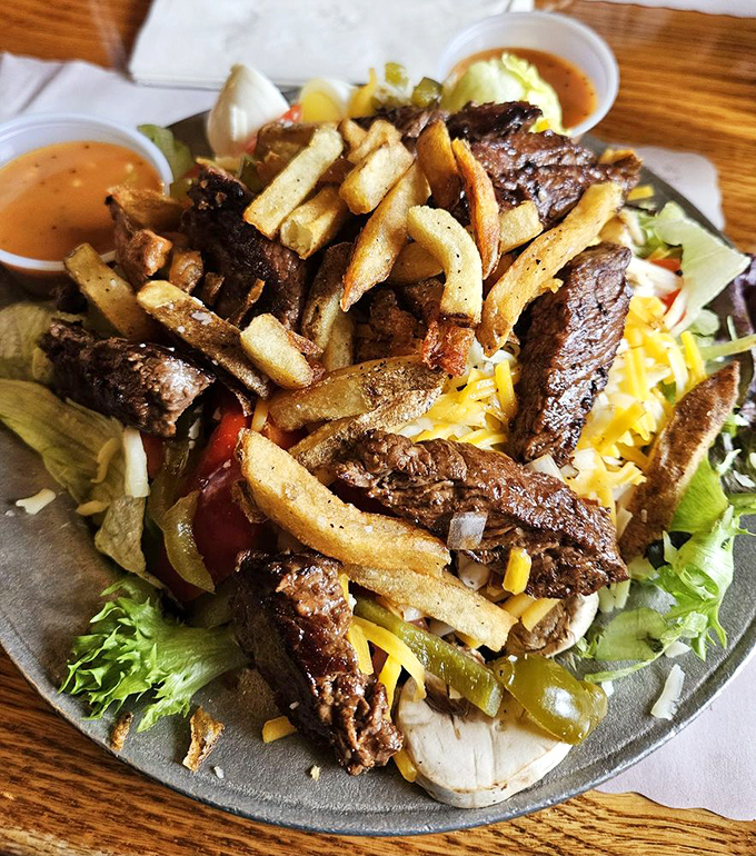 A salad that carnivores can embrace without shame&mdash;tender sirloin strips lounging atop fresh greens with fries playing the role of delicious, crunchy croutons.