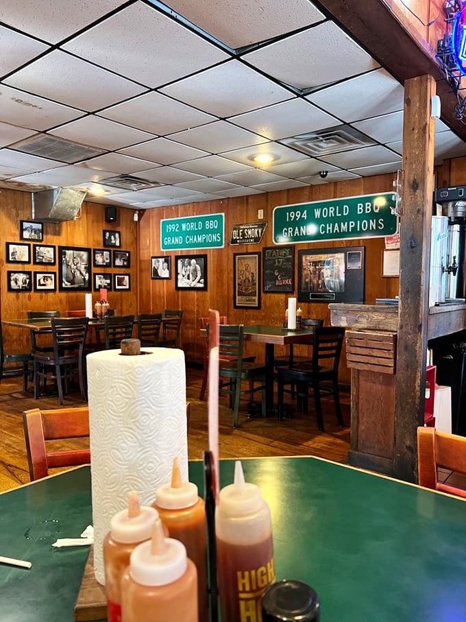 Every table tells a story&mdash;sauce bottles standing at attention like soldiers ready for duty, while championship banners remind you this isn't amateur hour.