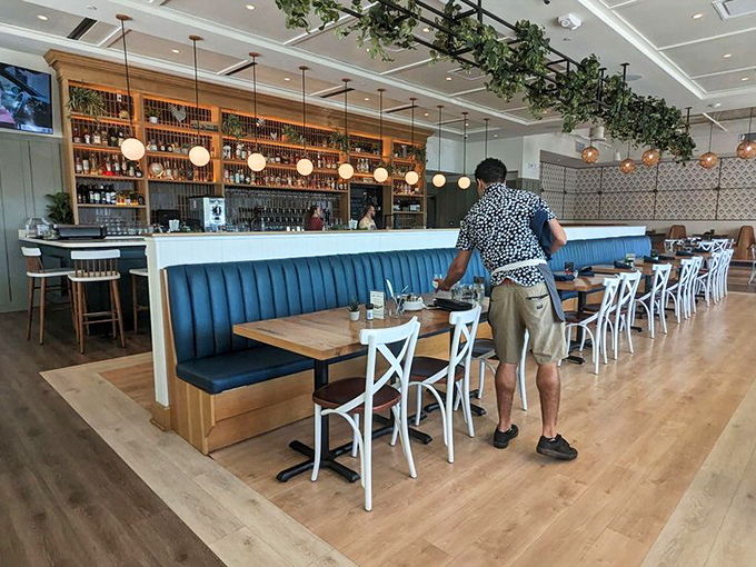 The bar area isn't just well-stocked&mdash;it's a shrine to libations with warm wood shelving, globe lighting, and enough spirits to make any cocktail enthusiast weak in the knees.