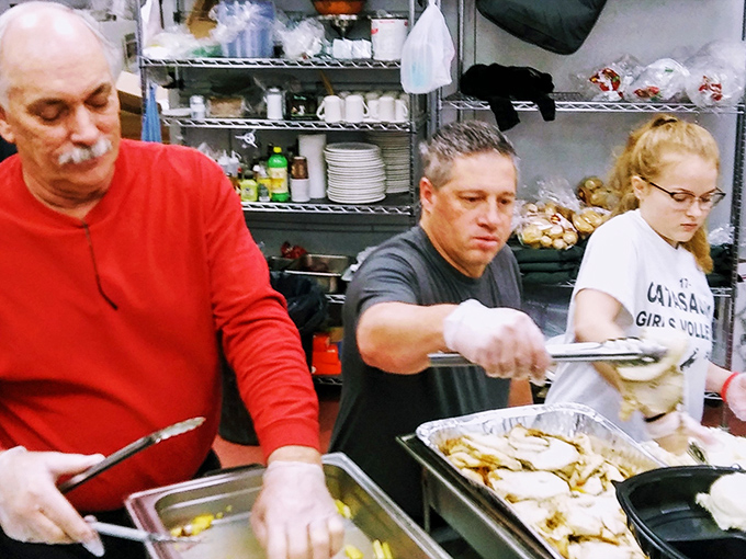 The kitchen crew in their element, orchestrating the pizza symphony that keeps locals coming back. True artisans at work.