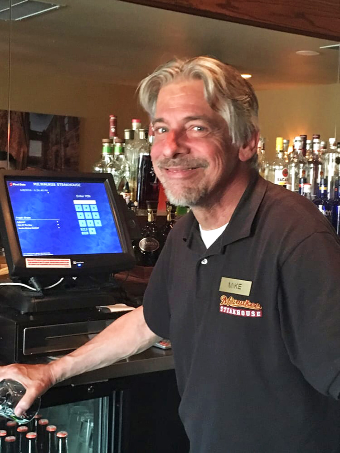 Behind every great steakhouse is a team that knows their craft&mdash;this friendly face at the bar ensures your glass is never lonely.