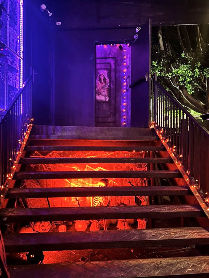 Even the staircase becomes part of the experience with glowing Halloween-themed step decorations below. 