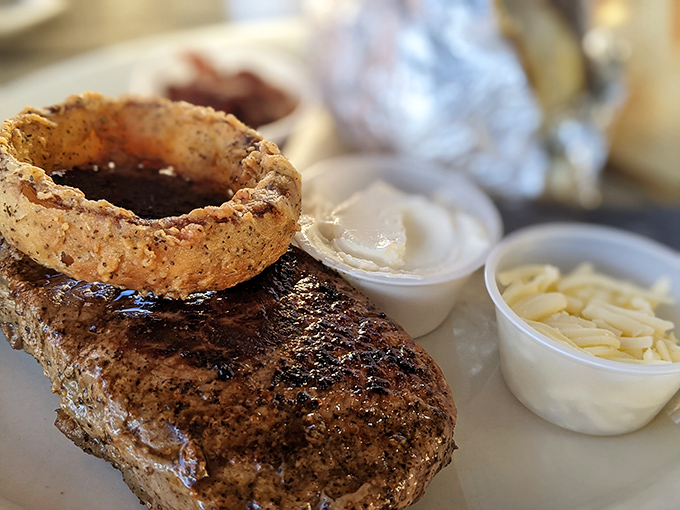 A perfectly seared steak topped with an onion ring crown. In Texas, even the garnishes demand respect.