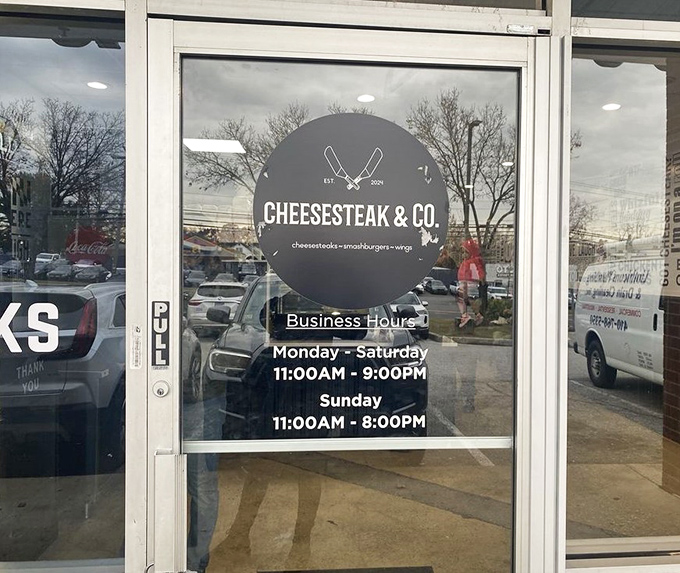 Business hours posted like a promise: "Yes, we'll be here when you need us." The cheesesteak craving waits for no one.