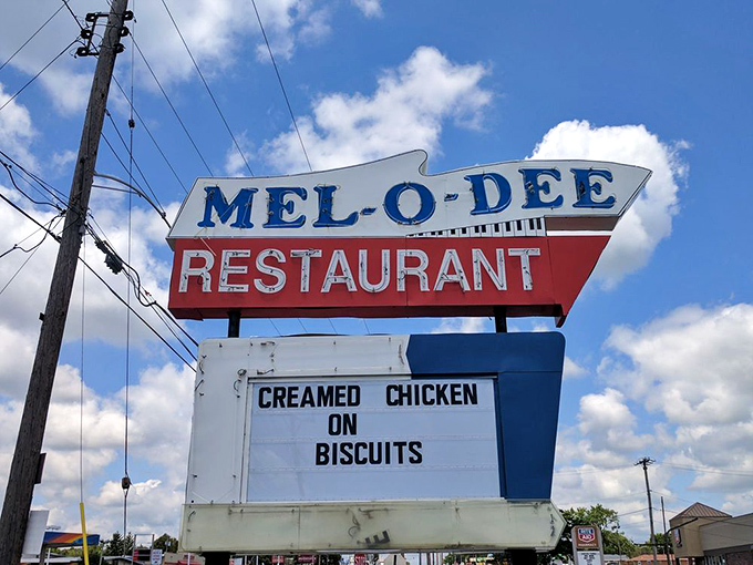 That vintage roadside sign with "Creamed Chicken on Biscuits" is practically a time machine to America's golden age of diners.