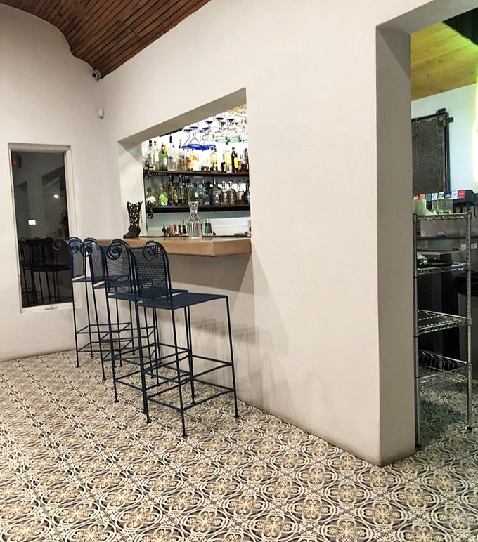 The intimate bar area feels like being let in on a secret, with patterned tile floors that Instagram influencers would fight over.