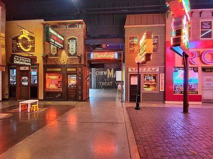 Main Street reimagined as a glowing gallery. The museum's clever layout creates intimate "storefronts" that showcase signs in their natural habitat.