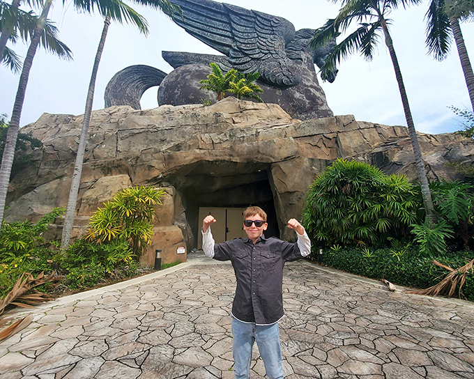 When you're dwarfed by a 100-foot mythological statue, the only reasonable response is to strike a victory pose.