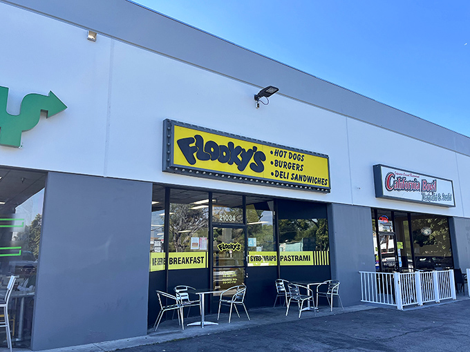 Flooky's bright yellow sign cuts through the noise with a simple message: serious hot dogs served here!