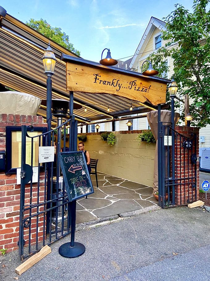 Frankly...Pizza!'s entrance feels like discovering a secret garden of flavor. That wooden sign and gate frame a pathway to pizza nirvana.
