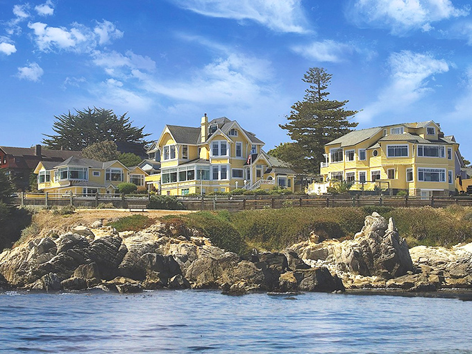 Pacific Grove: Cheerful yellow Victorian homes perch on the rocky coastline, their bright facades a stark contrast to the deep blue Pacific.