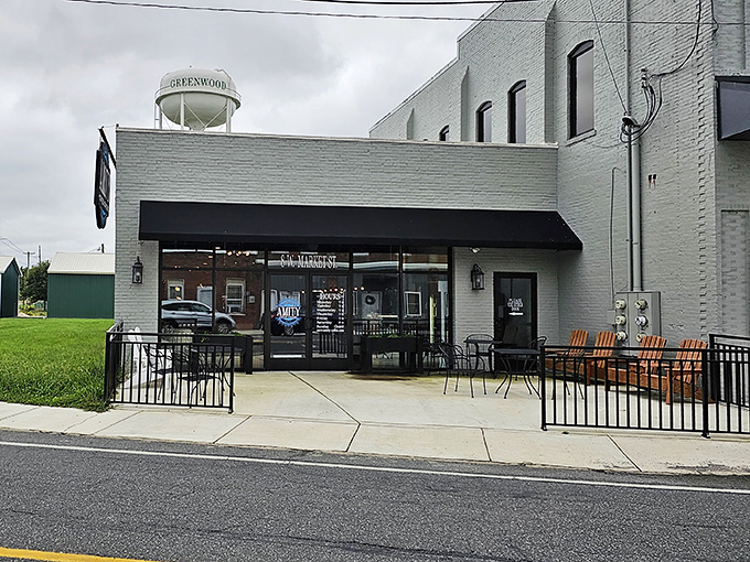 Small-town charm meets serious coffee at Amity Coffee Roasters, where the Greenwood water tower watches over quality brews.