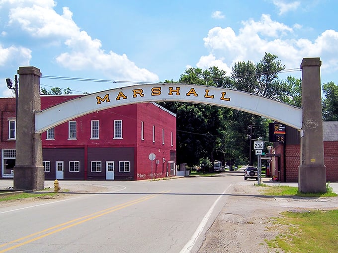 Marshall's iconic arch frames a view of the town's historic red brick buildings and small-town charm.