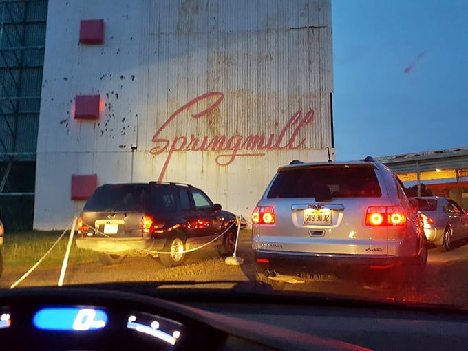 Springmill Drive-In at dusk, when that neon script begins to glow. Cars line up like eager moviegoers waiting for the main attraction.