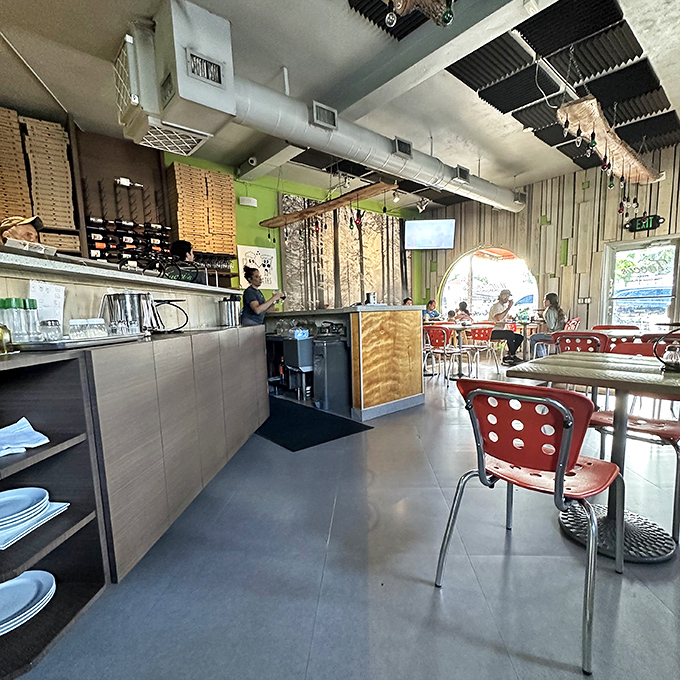 Inside Tucci's, industrial-chic design meets pizza perfection. Those red chairs invite you to sit down and stay awhile.