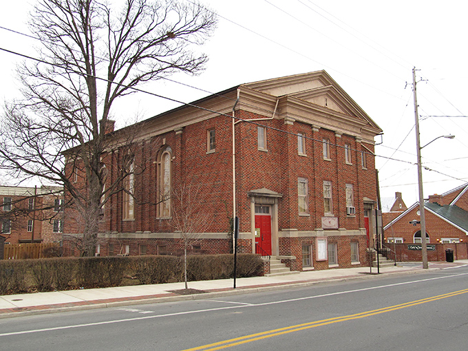 The stately brick buildings of Winchester stand like sentinels of history, their warm tones glowing in the afternoon sun.