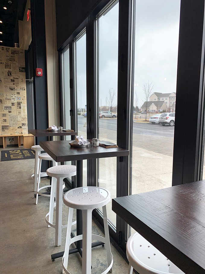 Window seats: where people-watching meets burger-eating in perfect harmony. These minimalist perches offer maximum enjoyment of both indoor and outdoor scenes.