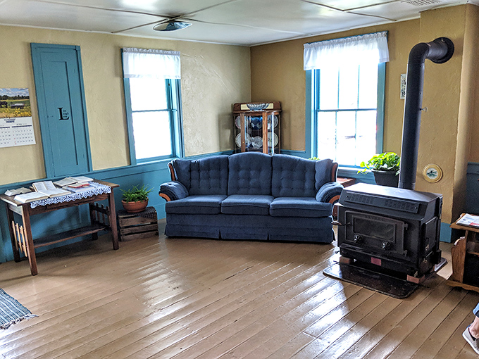The living room's wood stove isn't vintage decor&mdash;it's still the functional heart of an Amish home where warmth comes from fire, not furnaces.